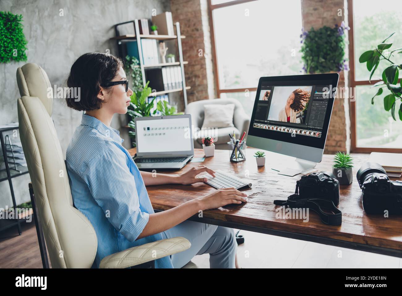 Photo of young woman professional photographer sit chair edit computer ...