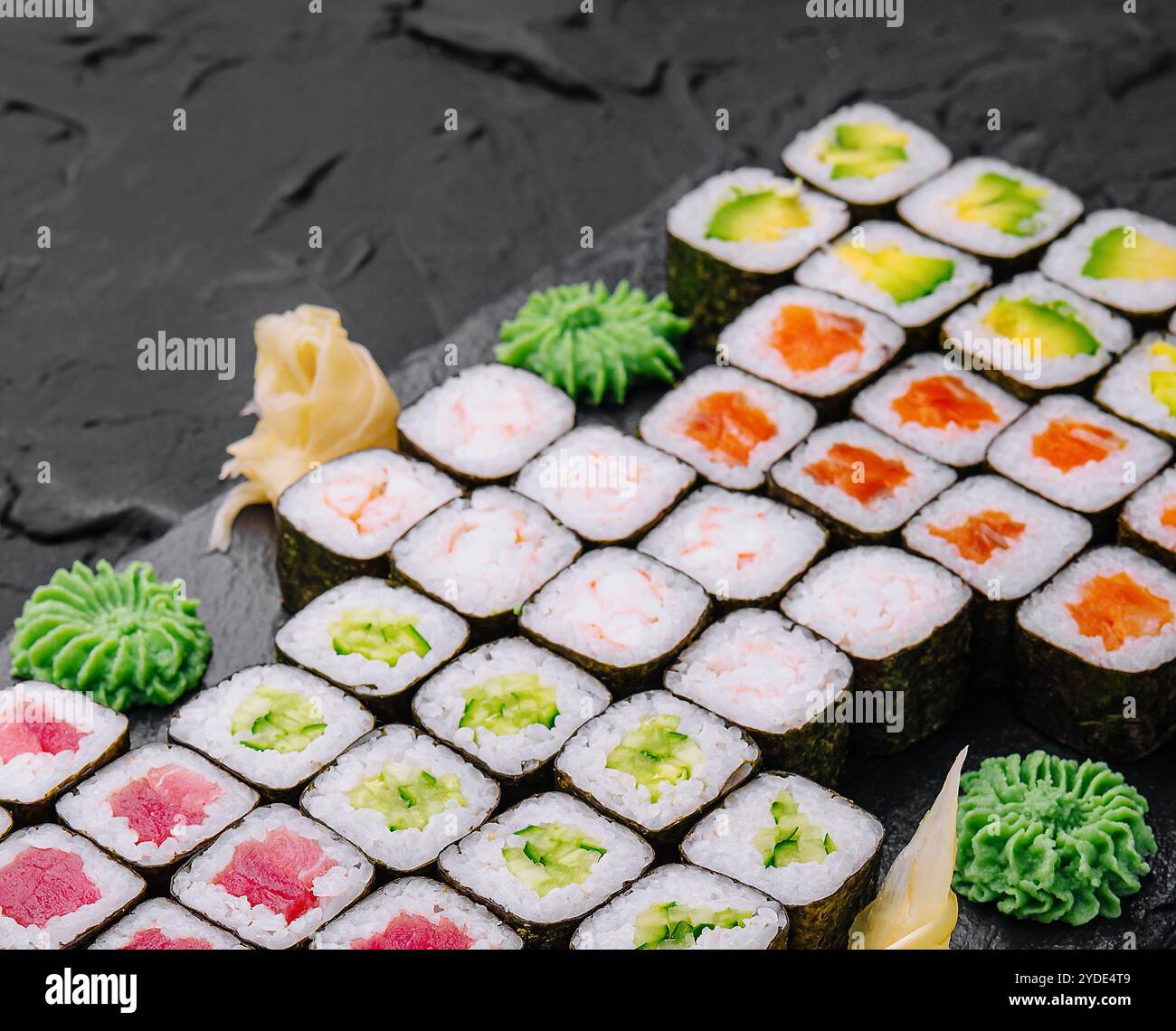 Maki sushi set served on black stone tray Stock Photo - Alamy