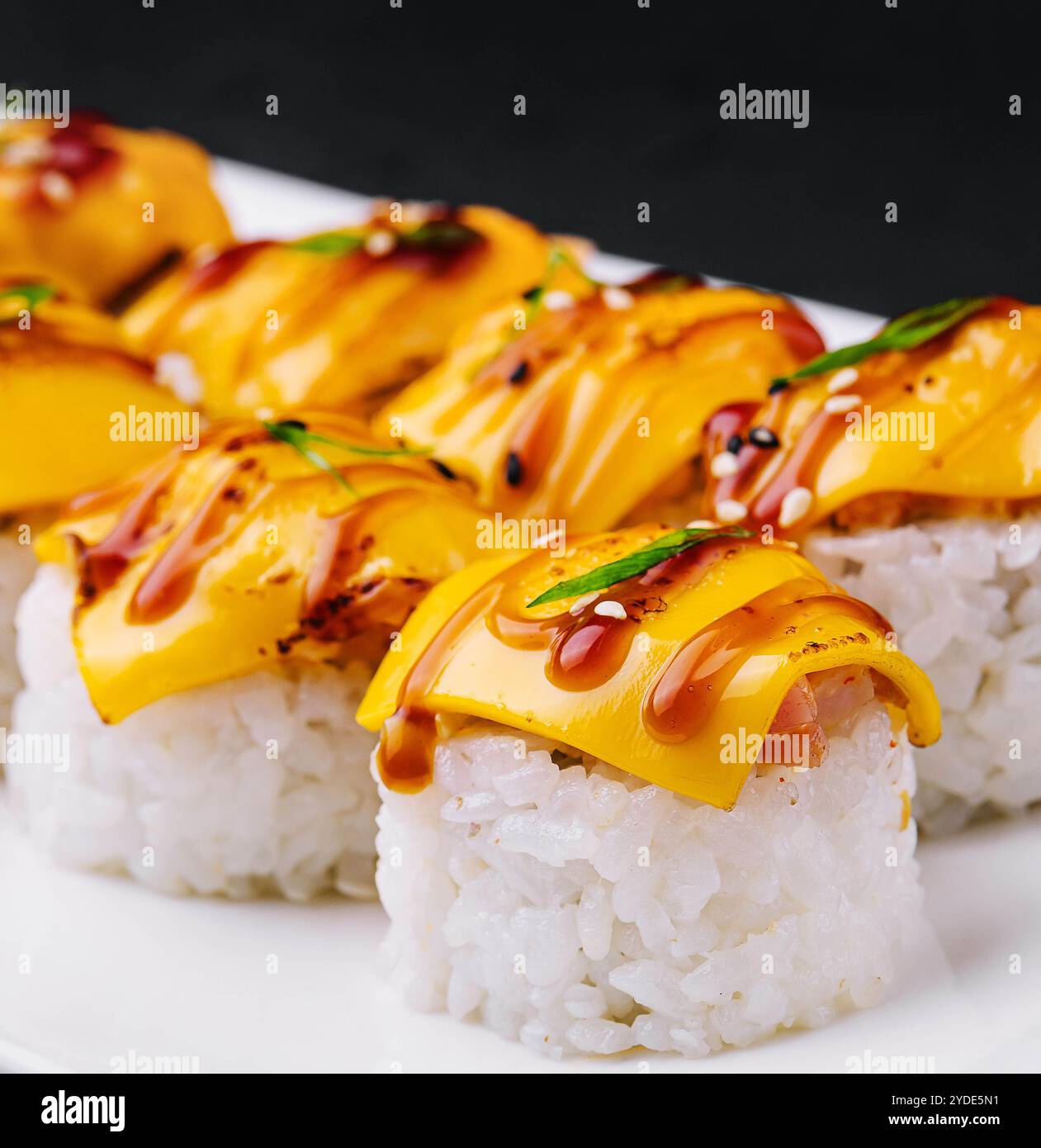 Vegan yellow maki sushi rolls on plate Stock Photo - Alamy