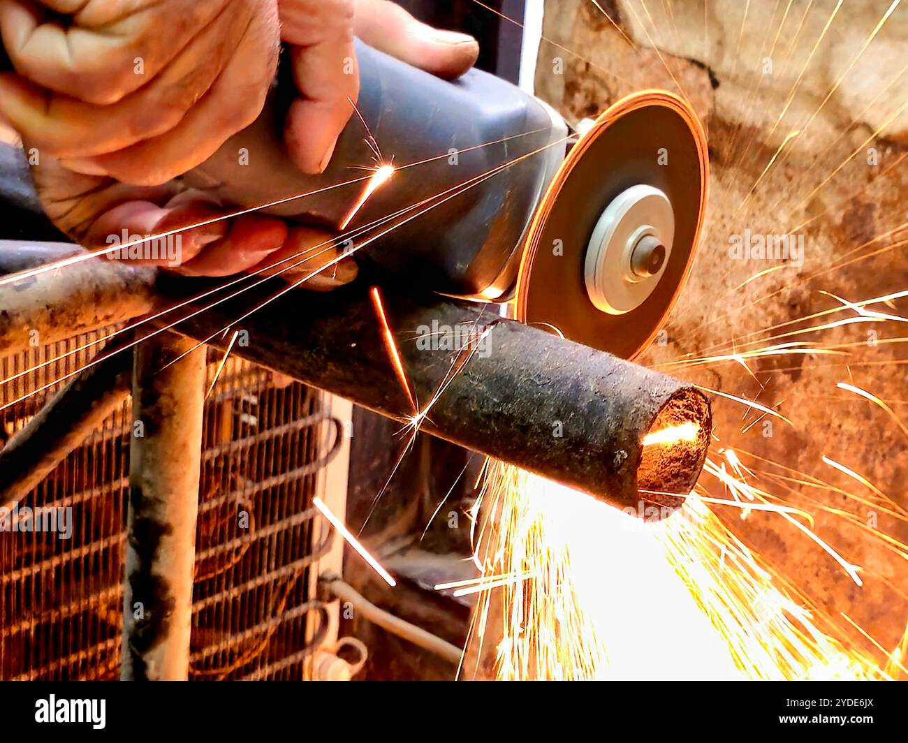 angle side disc grinder cutting steel with sparks, a handheld power ...