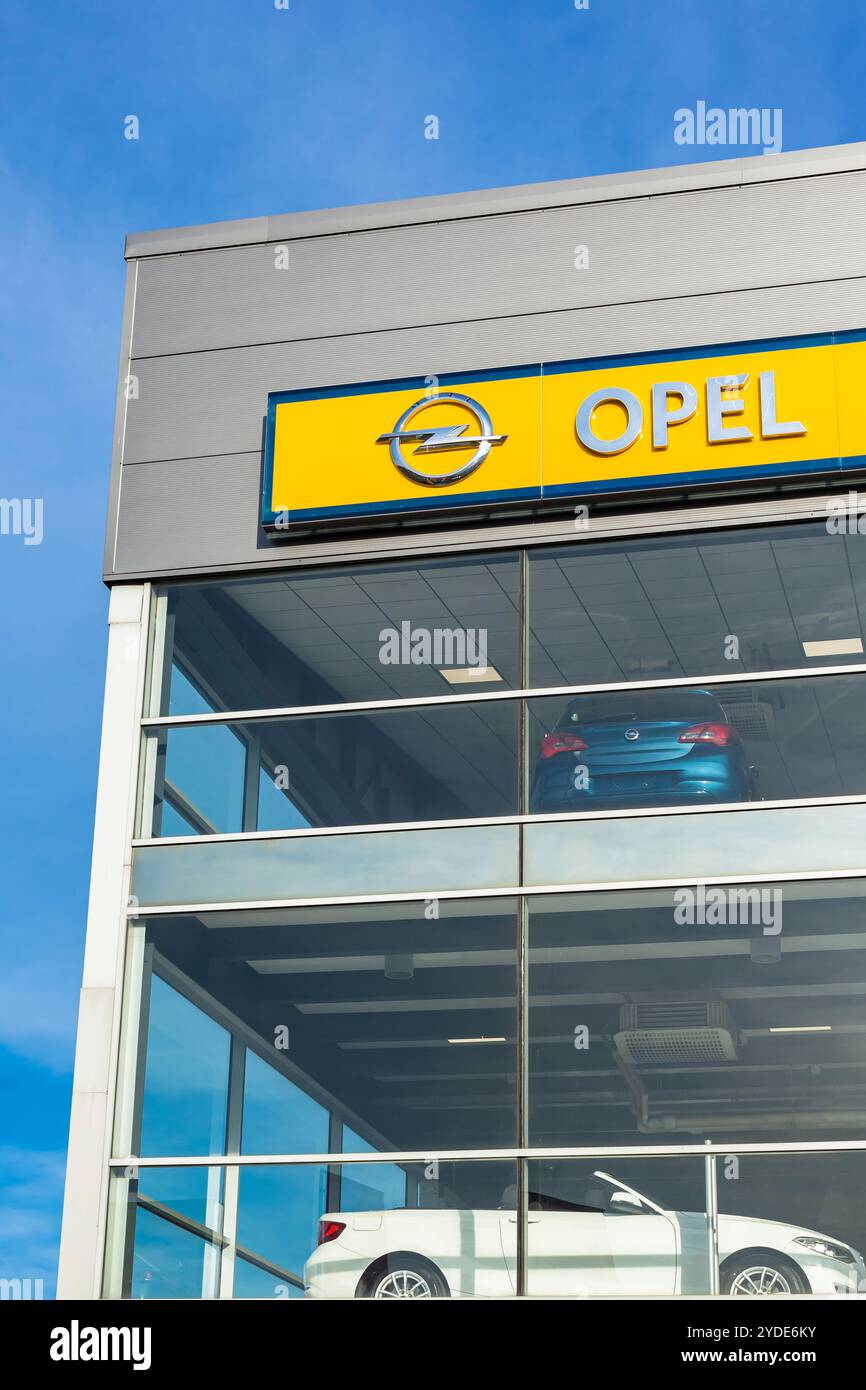 Opel brand logo on bright blue sky background Stock Photo - Alamy