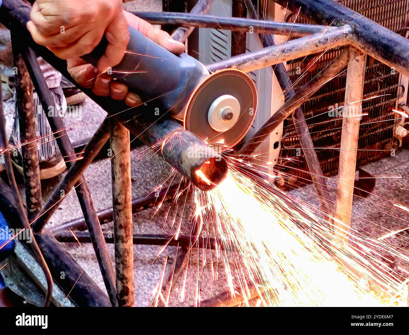 angle side disc grinder cutting steel with sparks, a handheld power ...