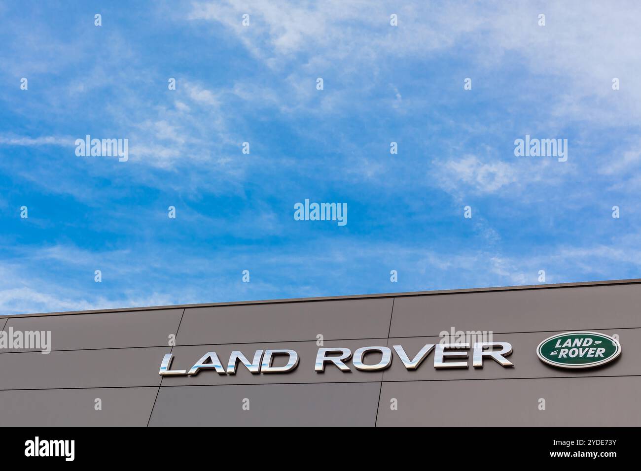 Land Rover brand logo, bright blue sky background Stock Photo - Alamy