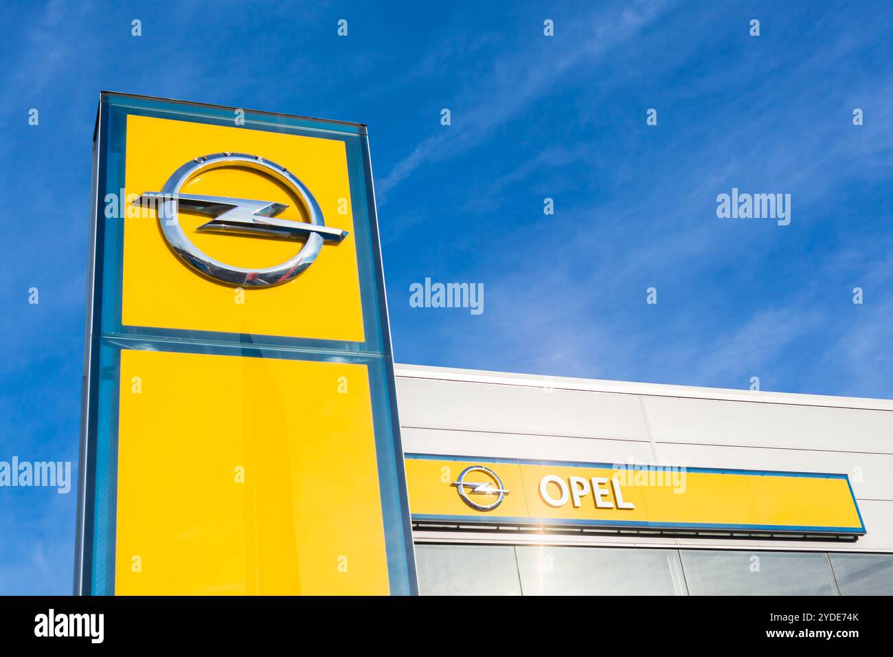 Opel brand logo on bright blue sky background Stock Photo - Alamy