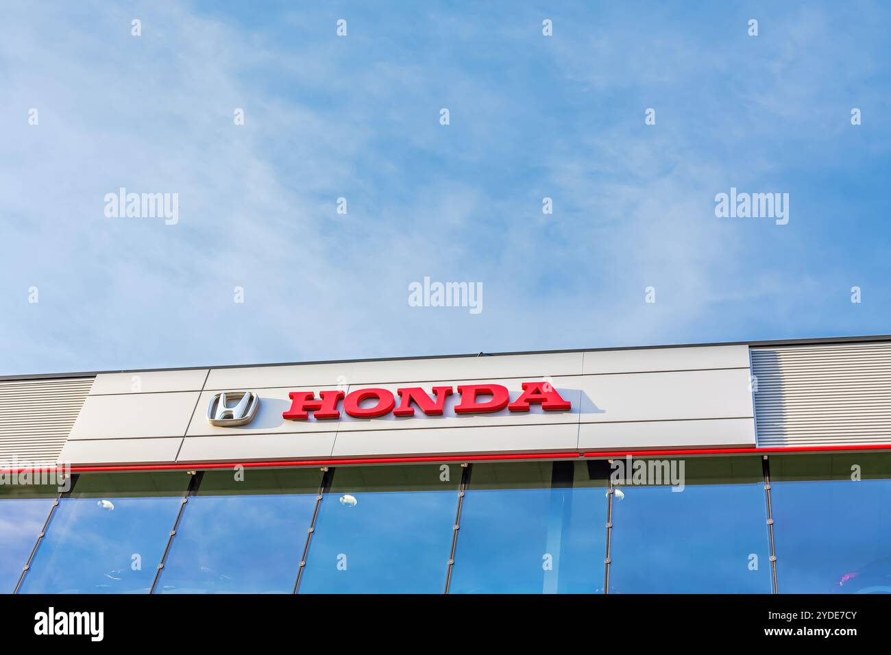 Honda brand logo on bright blue sky background Stock Photo - Alamy