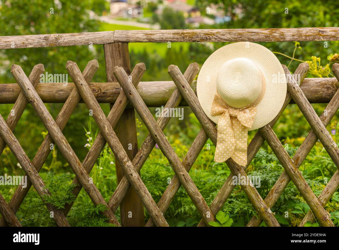 Female summer hat hanging on the wooden rustic fence Stock Photo - Alamy
