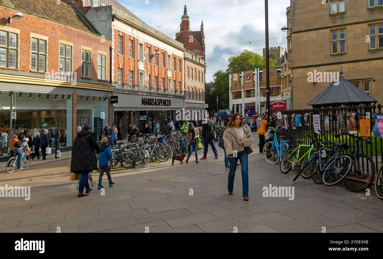 Shoppers in pedestrianised street by Marks and Spencer department store ...