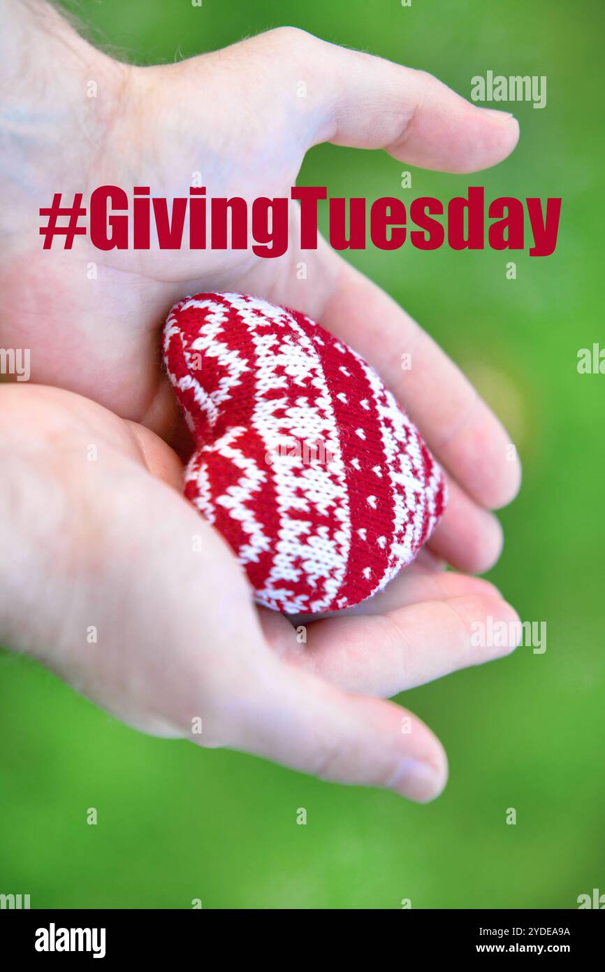 Giving Tuesday concept with red heart in hands Stock Photo - Alamy