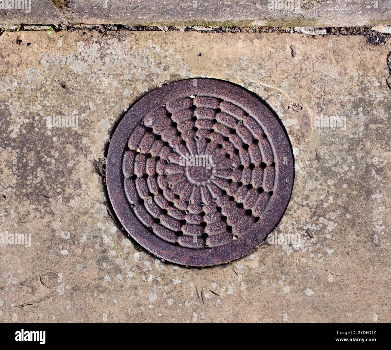 A cast iron coal plate set in a street paving slab Stock Photo - Alamy