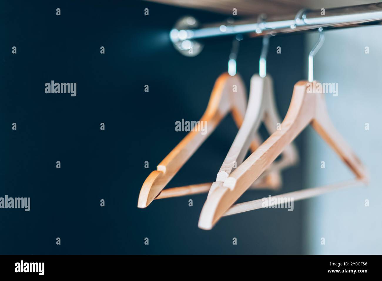 Wooden hangers in empty closet hi-res stock photography and images - Alamy