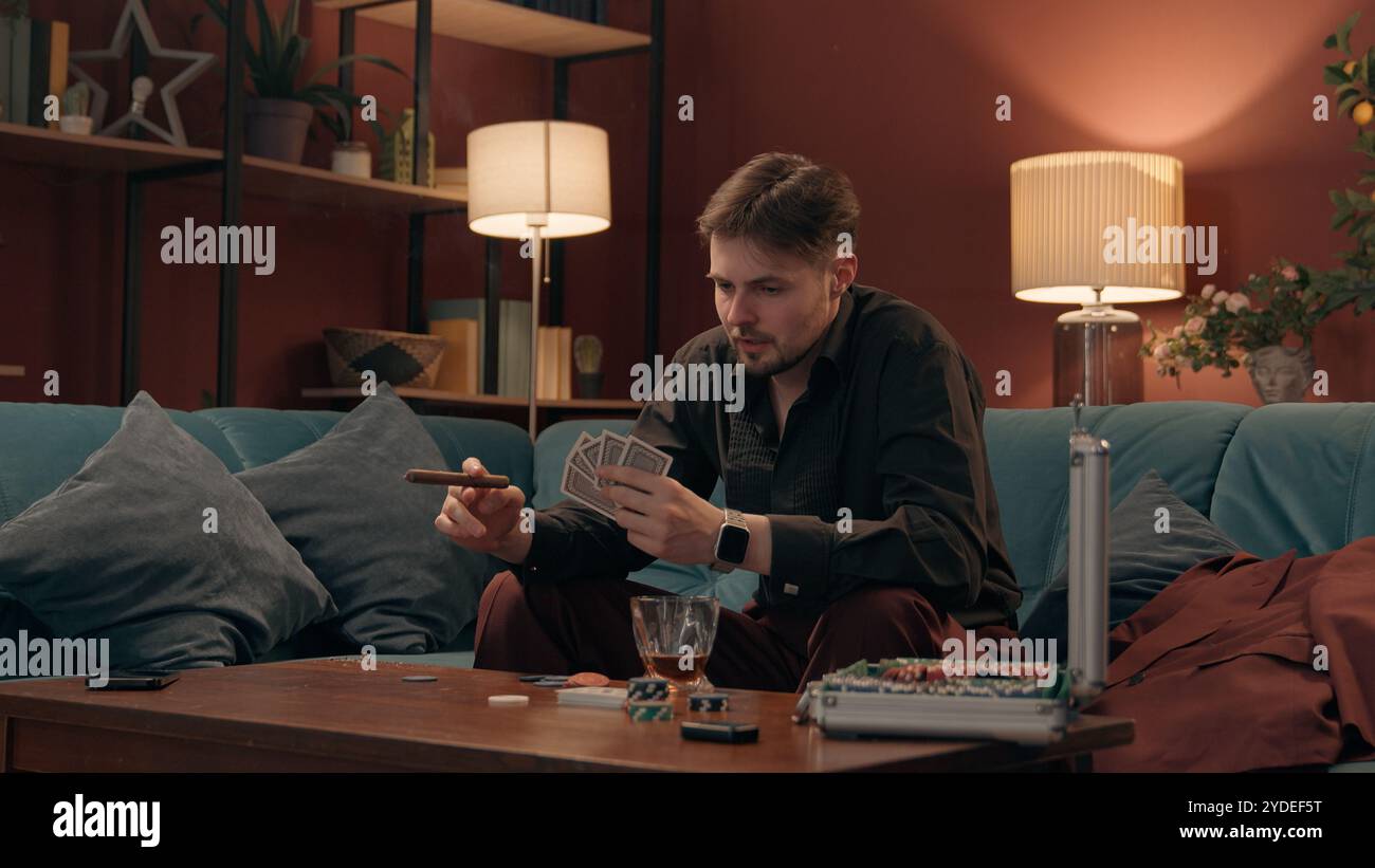 Depressed mad Caucasian angry male gambler gamer man guy smoking cigar ...