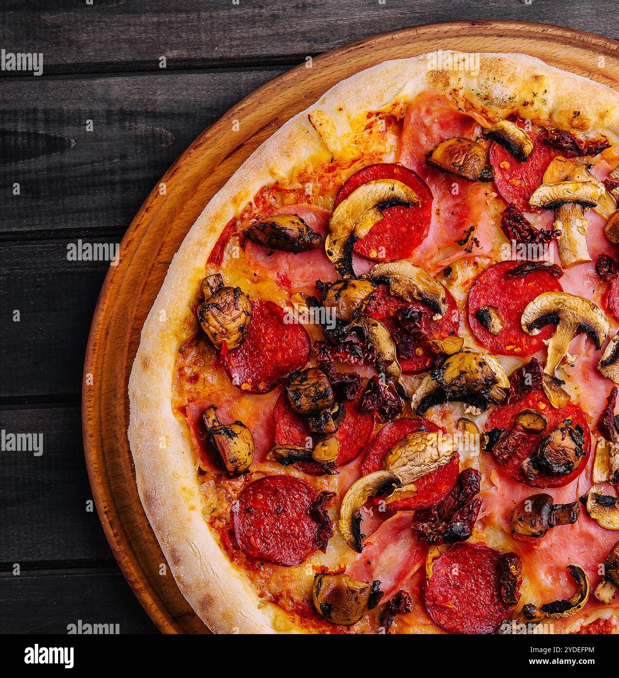 Pepperoni pizza with mushrooms on wood background Stock Photo - Alamy