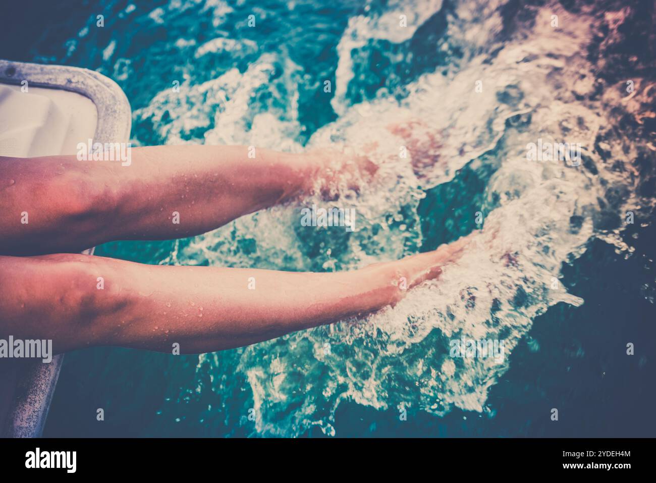 Female legs splashing sea water from a sailing yacht Stock Photo - Alamy