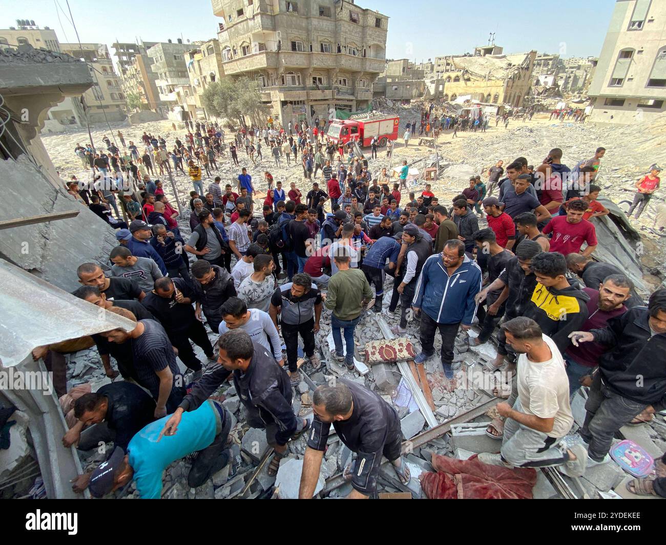 People work to recover Palestinian casualties from the rubble of a ...