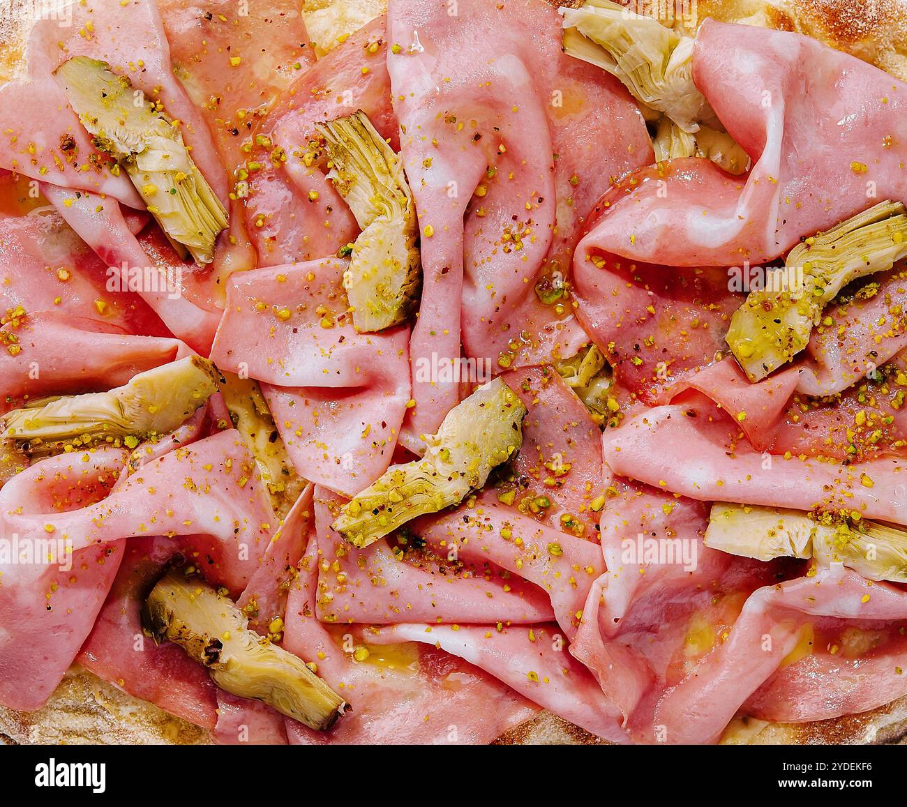 Square pizza with ham and artichokes top view Stock Photo - Alamy