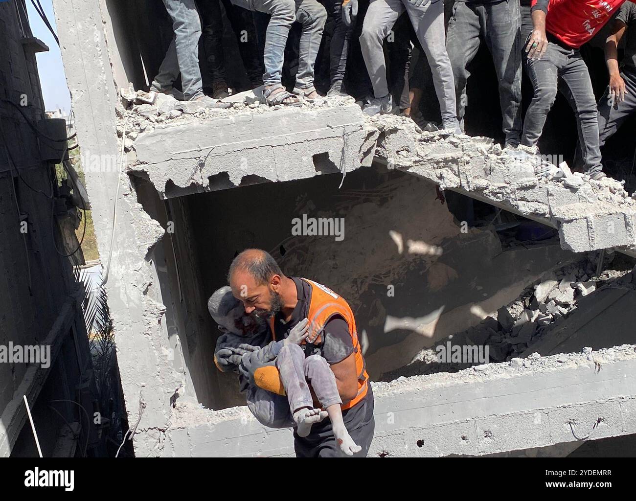 People work to recover Palestinian casualties from the rubble of a ...