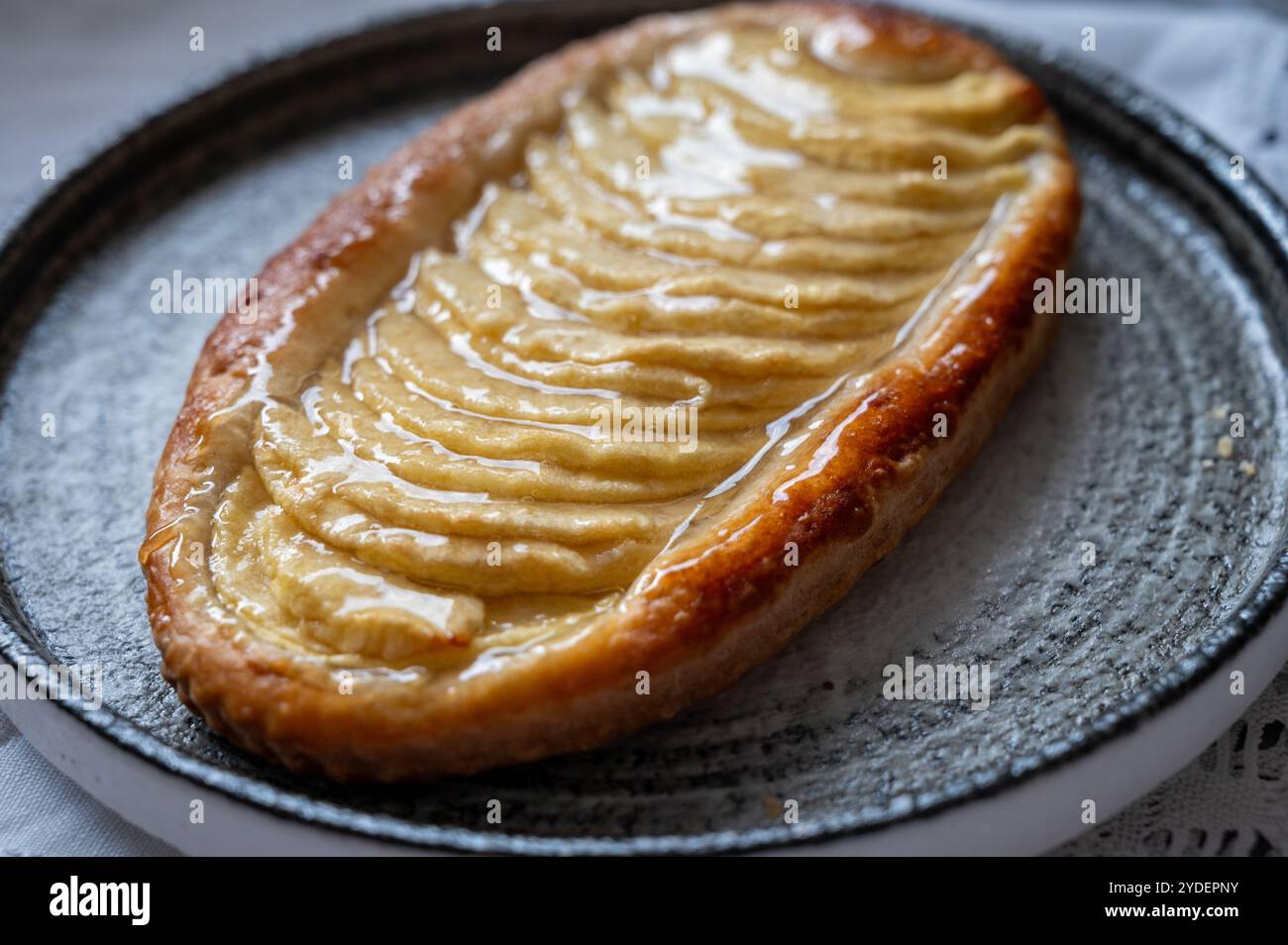 French fresh baked sweet puff pastry with fresh apple fruits in sirup ...