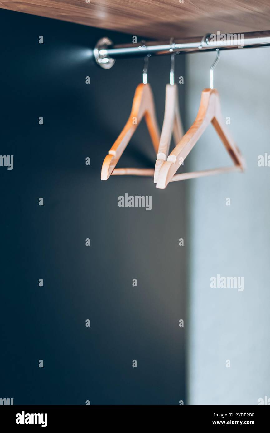 Empty Wooden hangers on rail in closet Stock Photo - Alamy