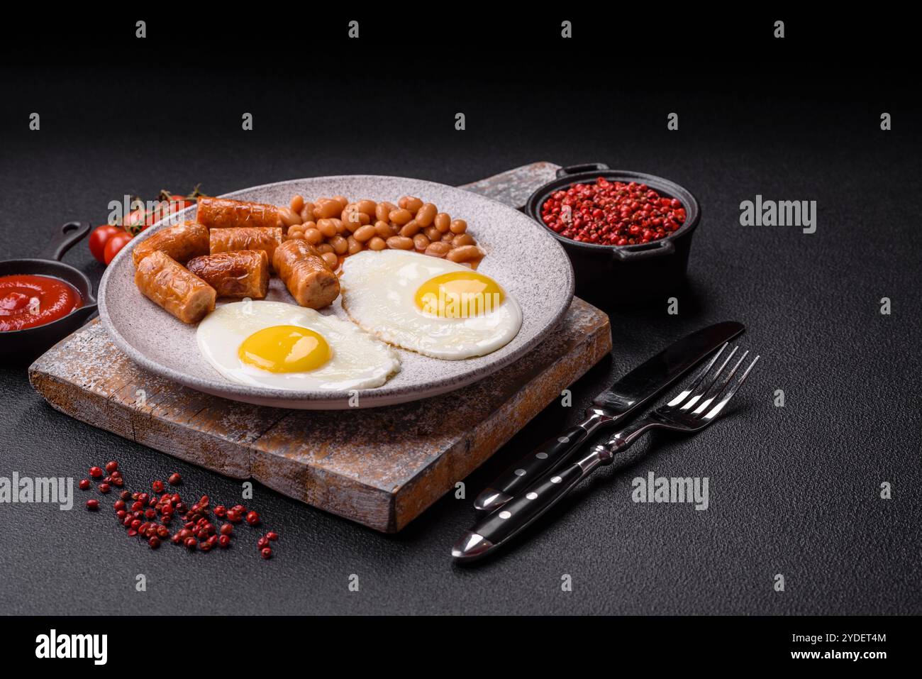 Full English breakfast with boiled eggs, beans, sausages, tomatoes ...