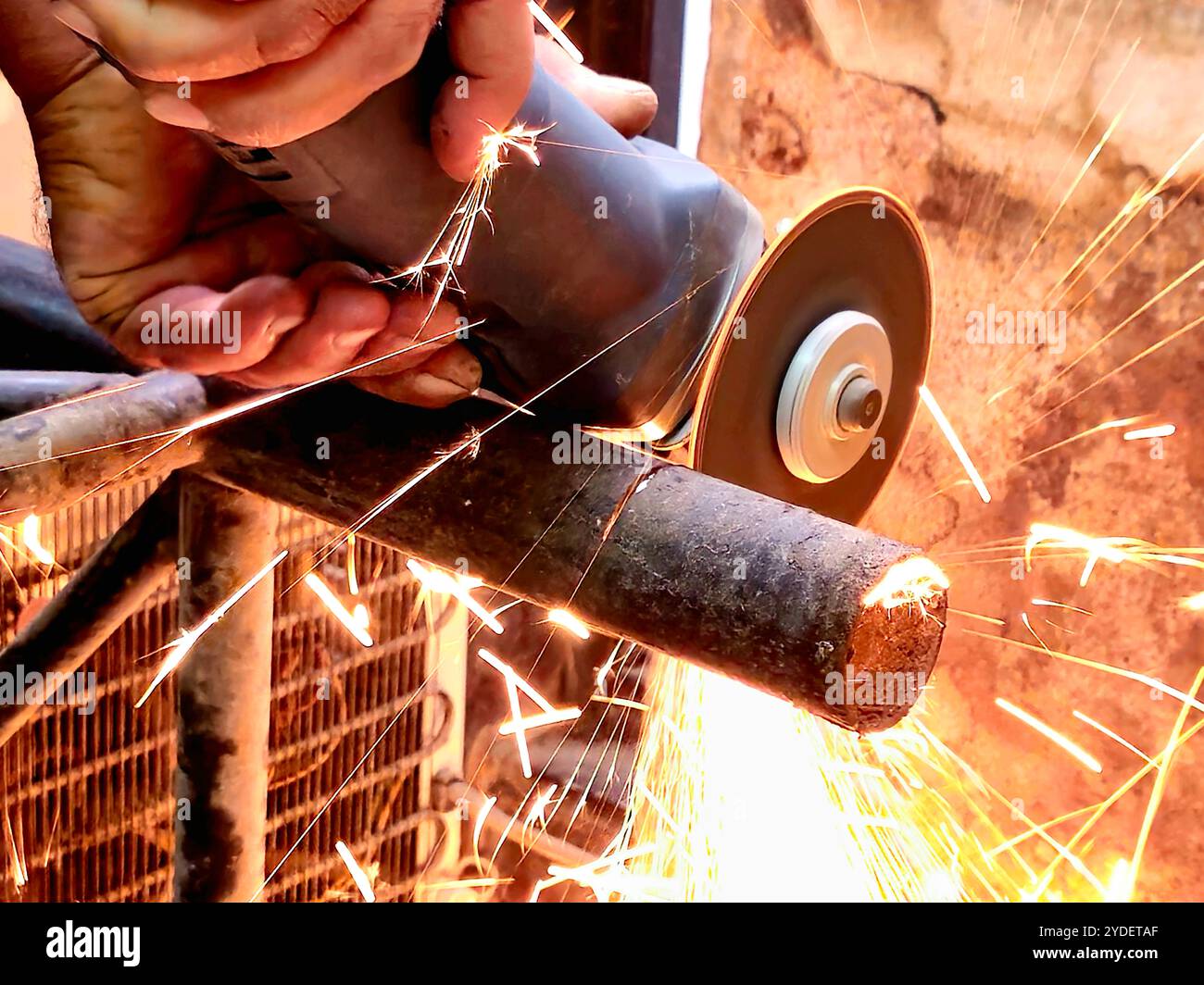 angle side disc grinder cutting steel with sparks, a handheld power ...