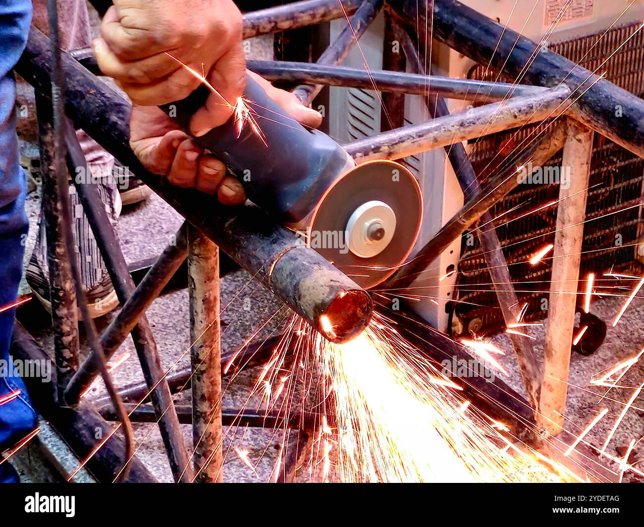 angle side disc grinder cutting steel with sparks, a handheld power ...