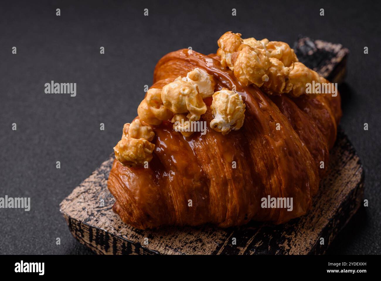 Sweet crispy croissant with salted caramel and glazed popcorn Stock ...