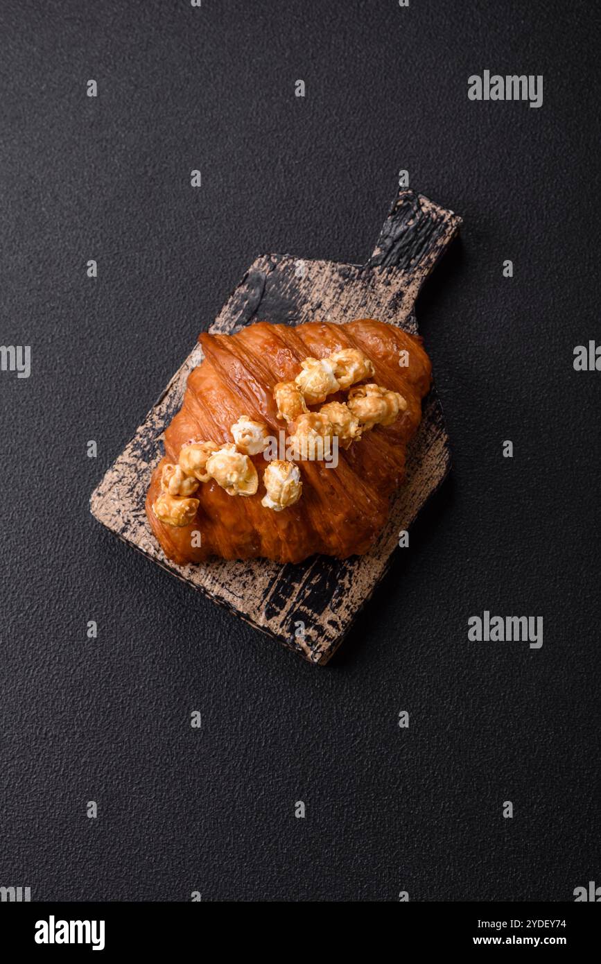 Sweet crispy croissant with salted caramel and glazed popcorn Stock ...