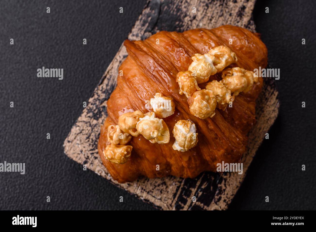 Sweet crispy croissant with salted caramel and glazed popcorn Stock ...