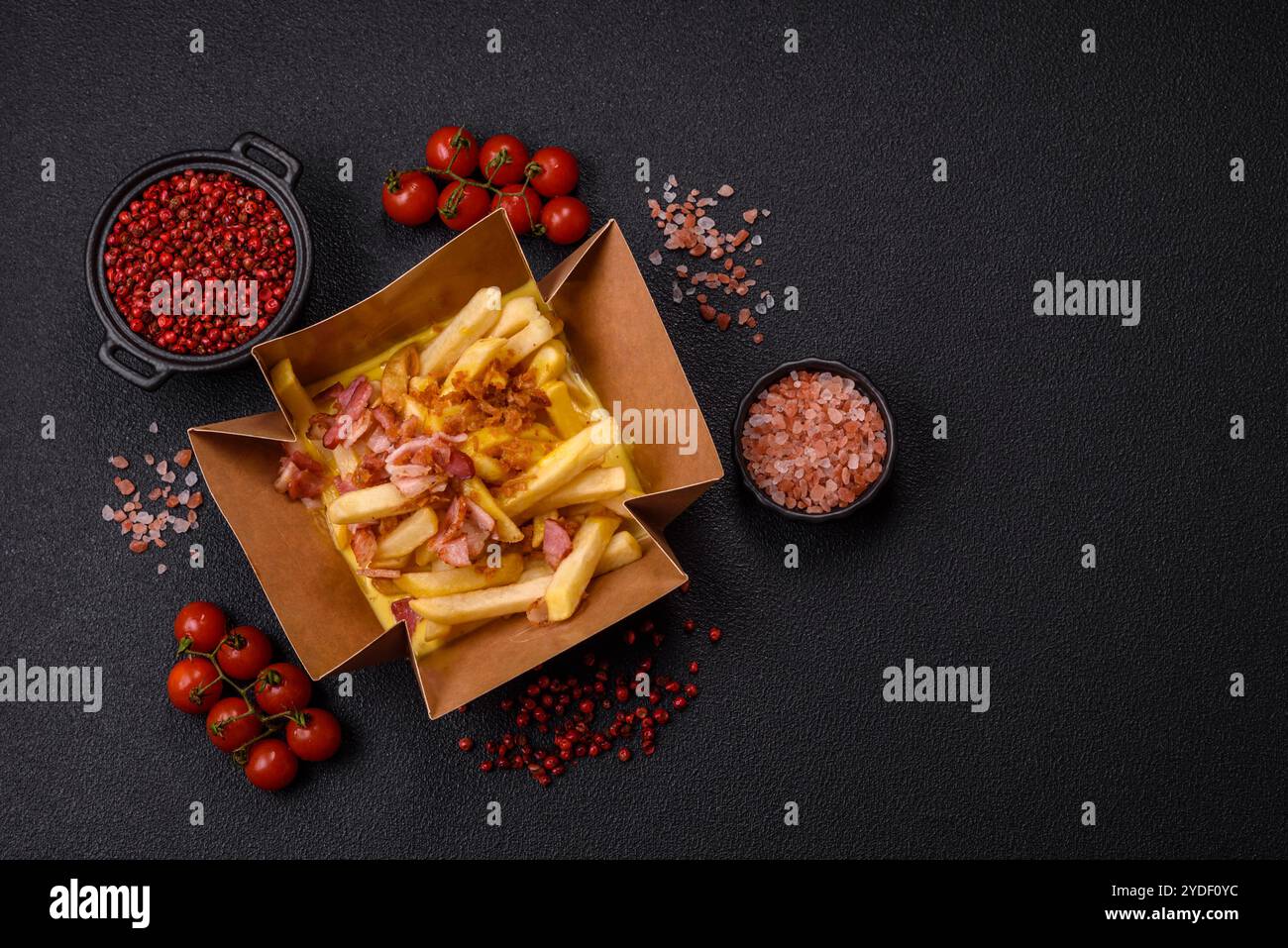 Crispy French fries with pieces of bacon, salt and spices Stock Photo ...