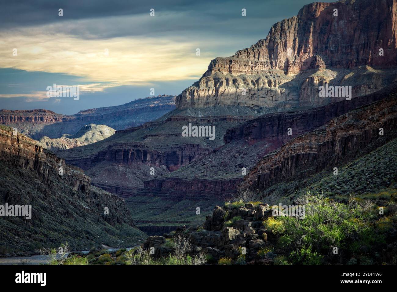 The steep walls of the Grand Canyon glow in the broken afternoon ...