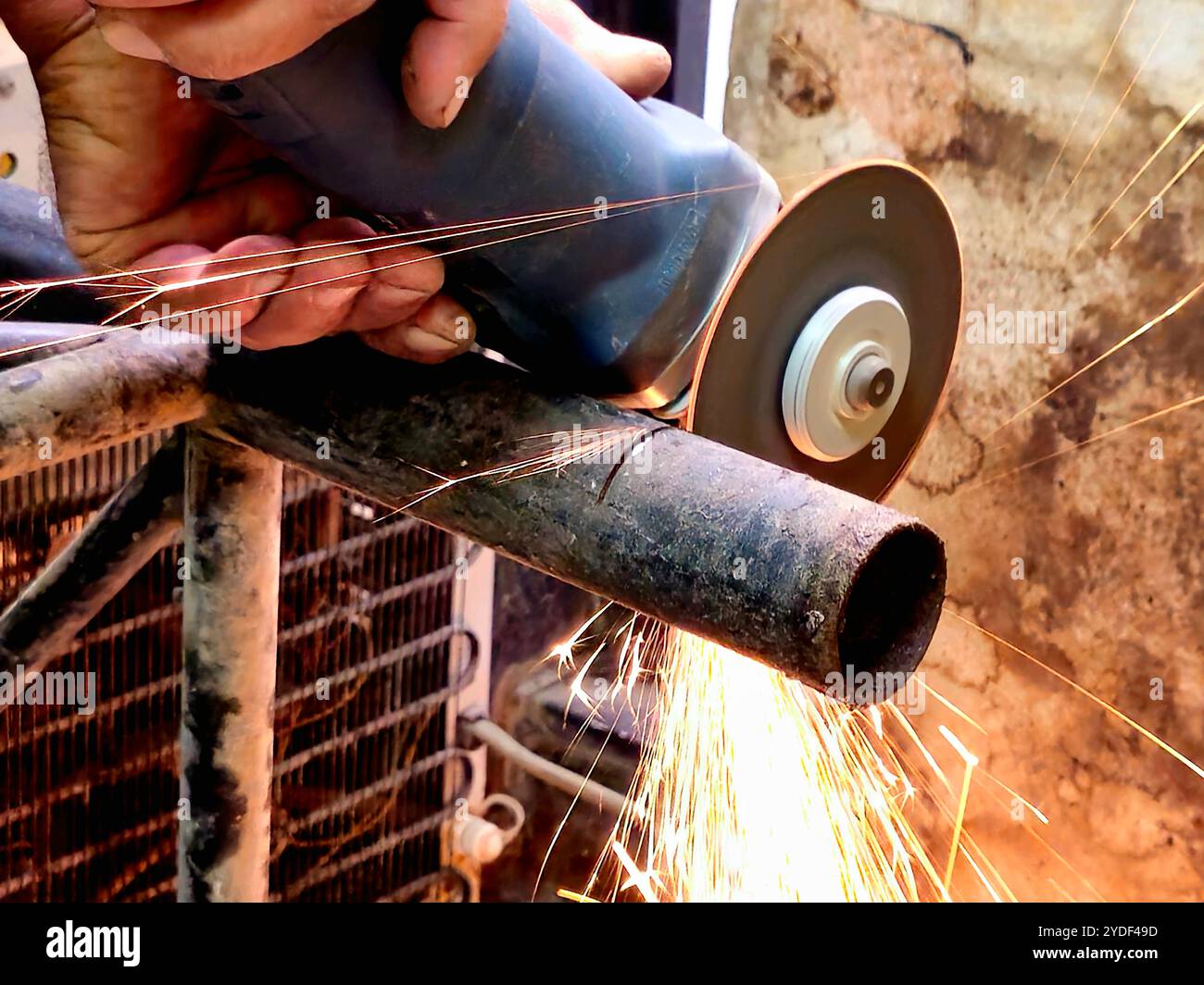 angle side disc grinder cutting steel with sparks, a handheld power ...