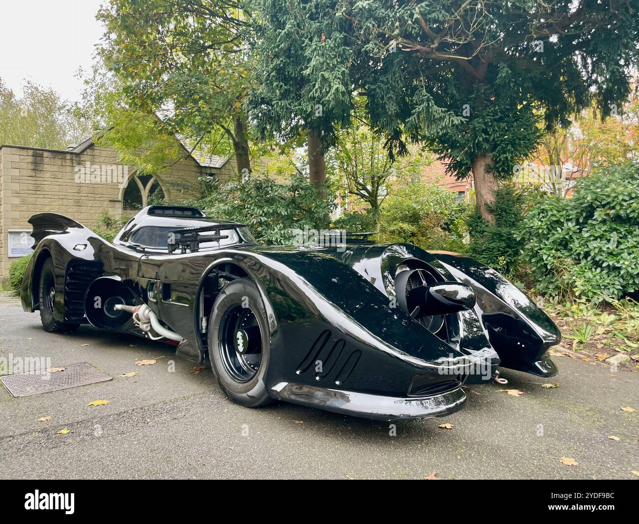 a replica of the bat mobile in a church grounds for use as a prop for a ...
