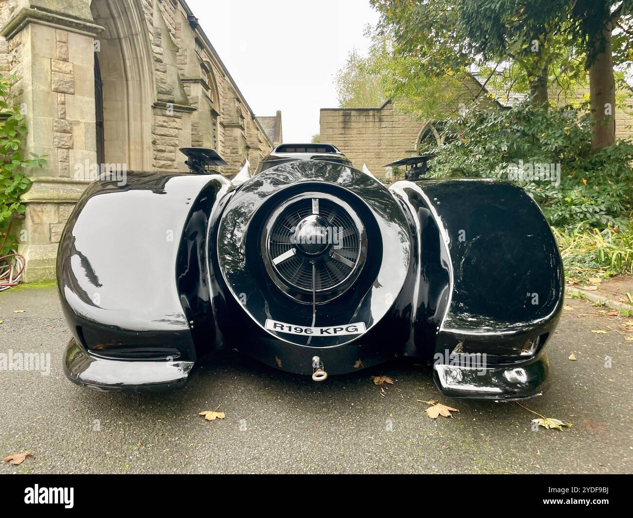 a replica of the bat mobile in a church grounds for use as a prop for a ...