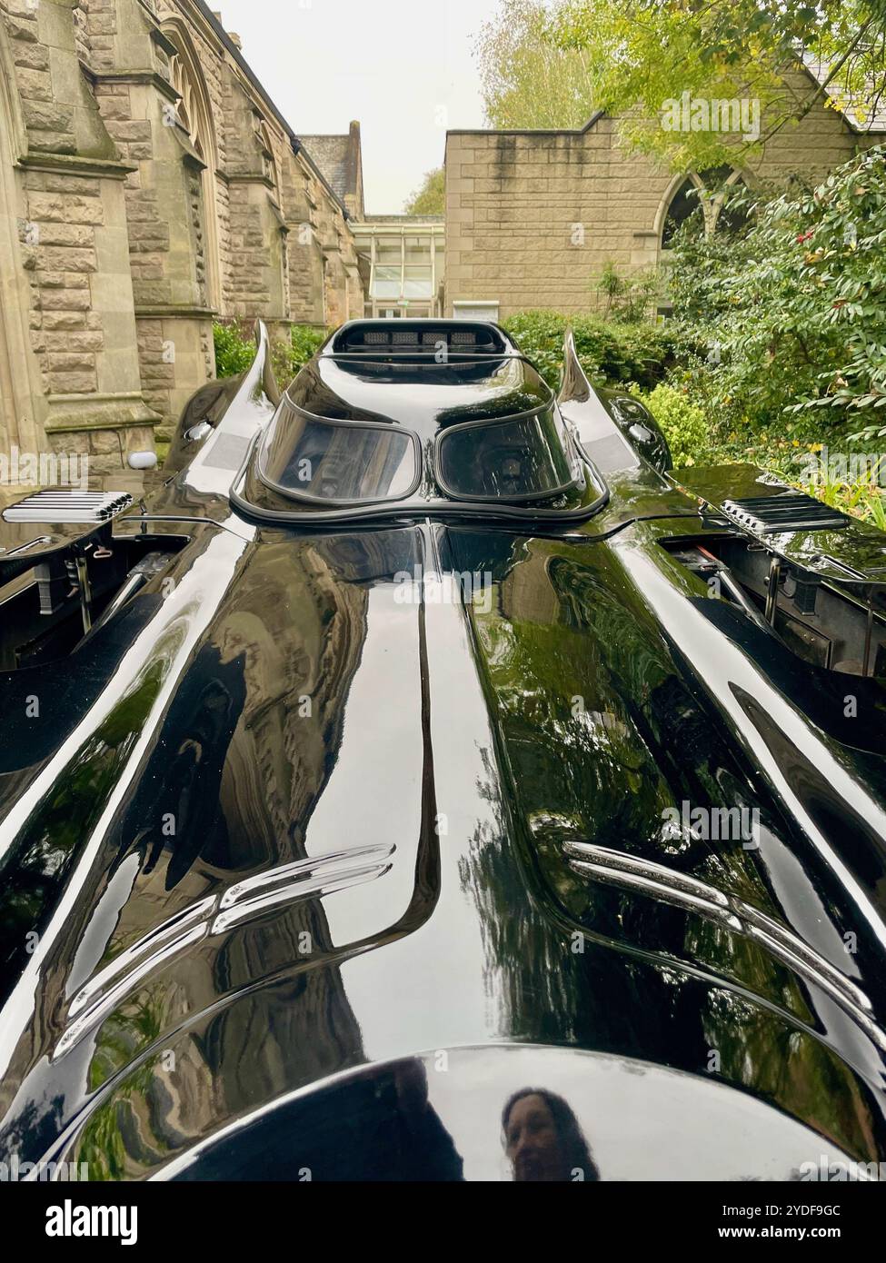a replica of the bat mobile in a church grounds for use as a prop for a ...