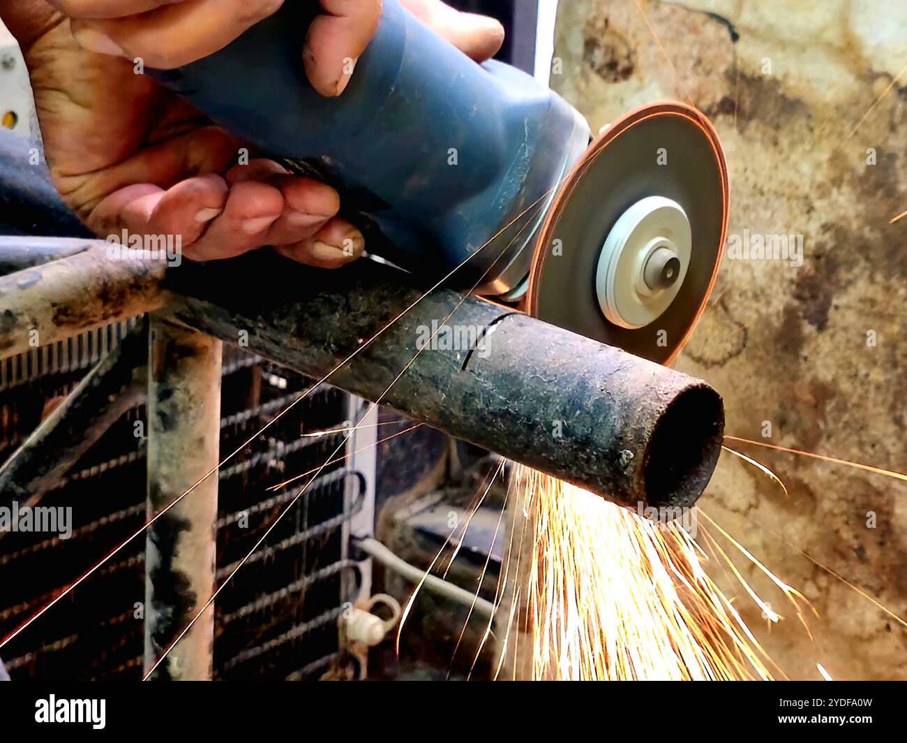 angle side disc grinder cutting steel with sparks, a handheld power ...