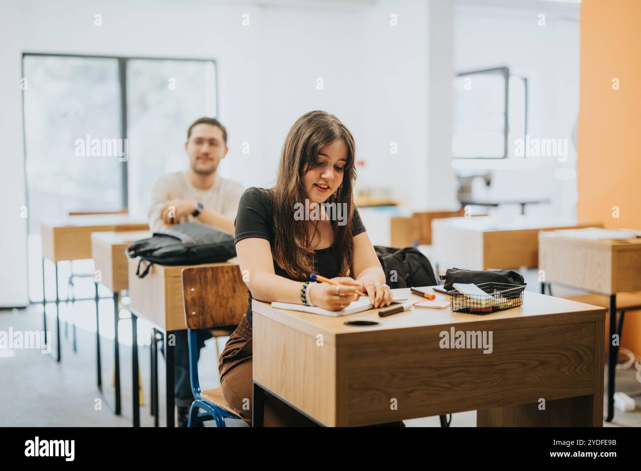 Focused high school students engaged in classroom activities Stock ...