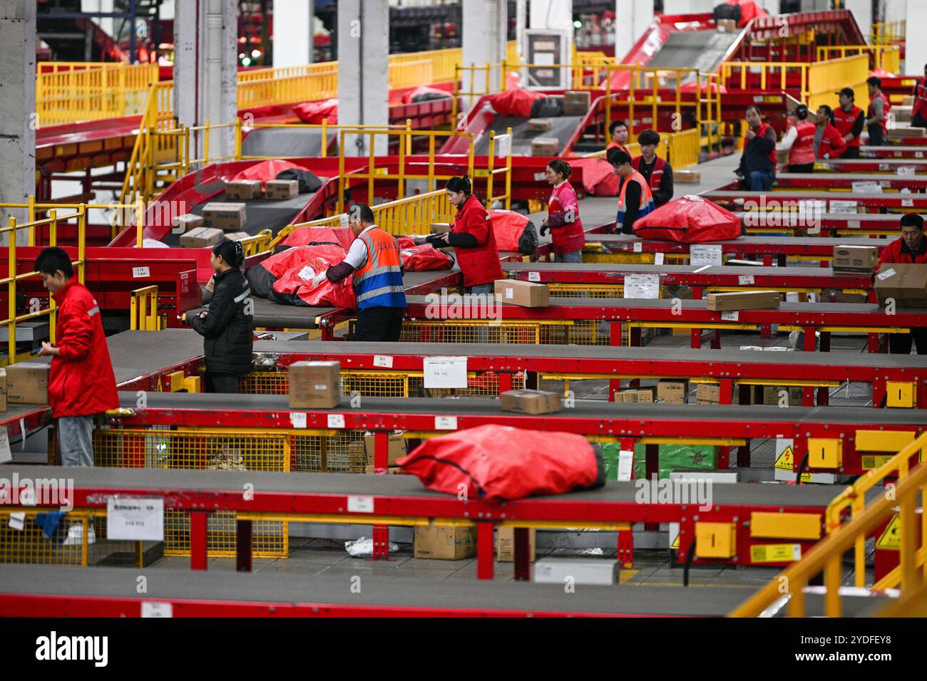 NANJING, CHINA - OCTOBER 26, 2024 - Workers sort express deliveries on ...