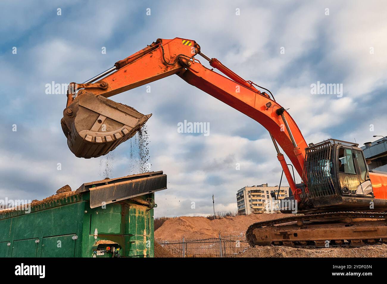 Excavator loads soil in mobile crushing and sorting complex Stock Photo ...