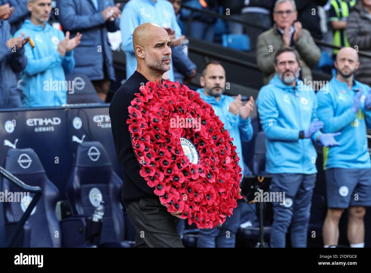 Pep Guardiola manager of Manchester City walks out with poppy wreath ...
