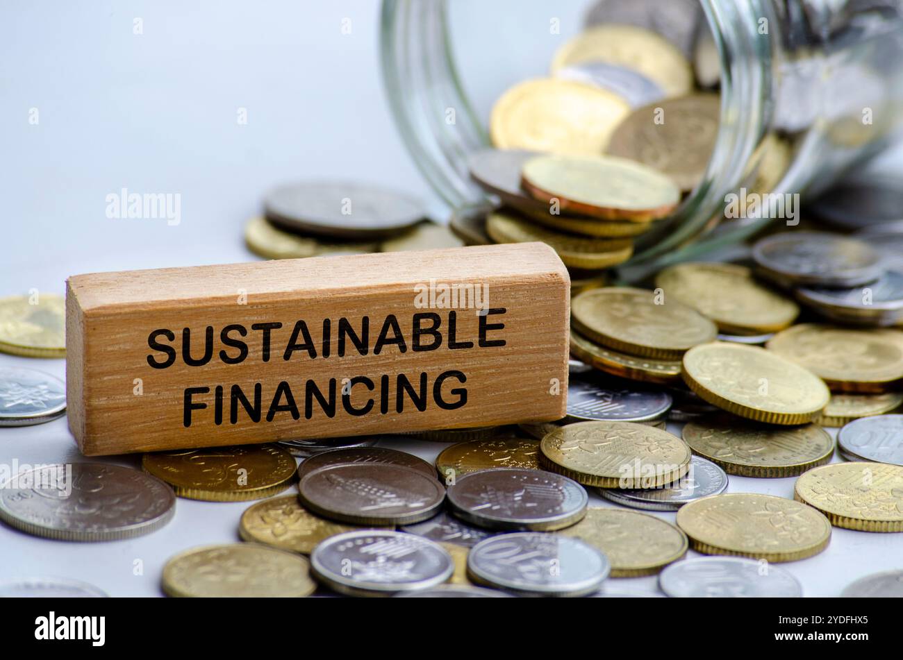 Sustainable Financing text on white wooden block with coins and jar ...