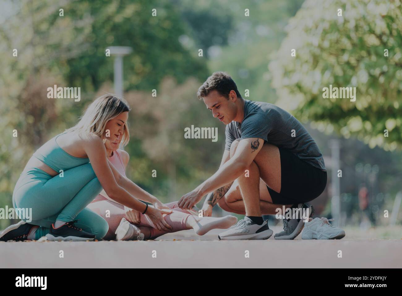 Friends helping each other during exercise session in the park Stock ...