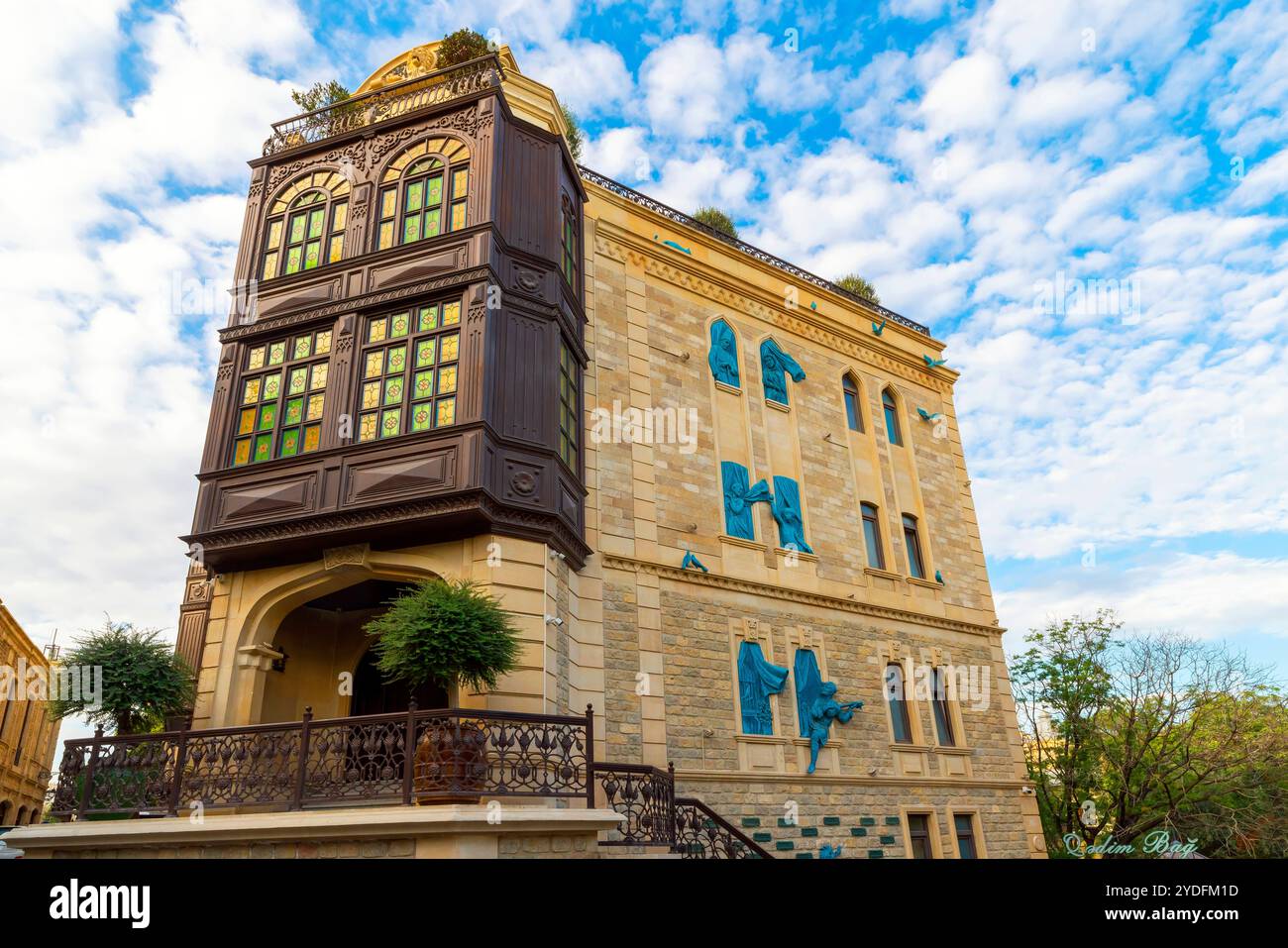 A traditional Azerbaijani building with ornate wooden balcony by Qüllə ...