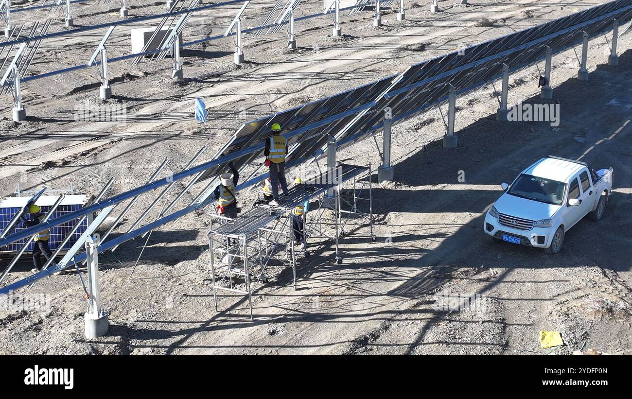 HAMI, CHINA - OCTOBER 26, 2024 - Workers install photovoltaic panels on ...