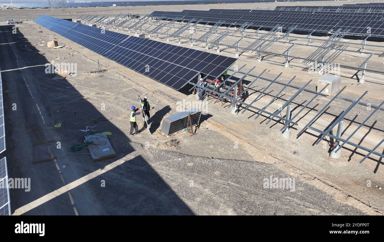 HAMI, CHINA - OCTOBER 26, 2024 - Workers install photovoltaic panels on ...