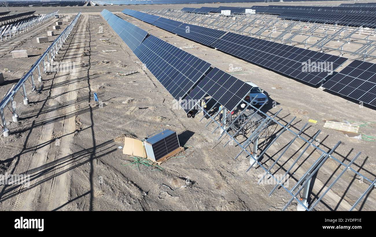 HAMI, CHINA - OCTOBER 26, 2024 - Workers install photovoltaic panels on ...
