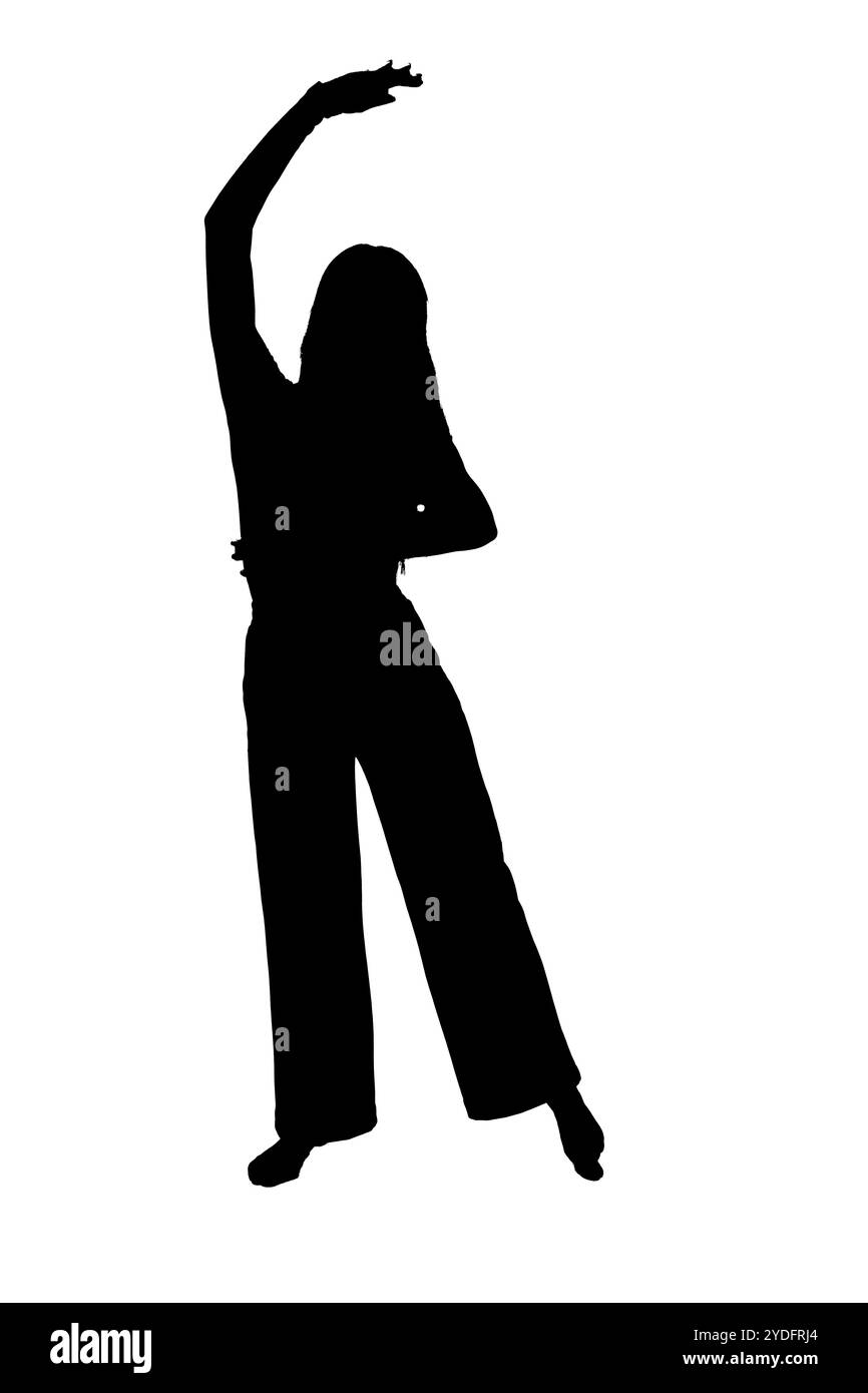 A beautiful silhouette of a woman joyfully dancing with her arms raised ...