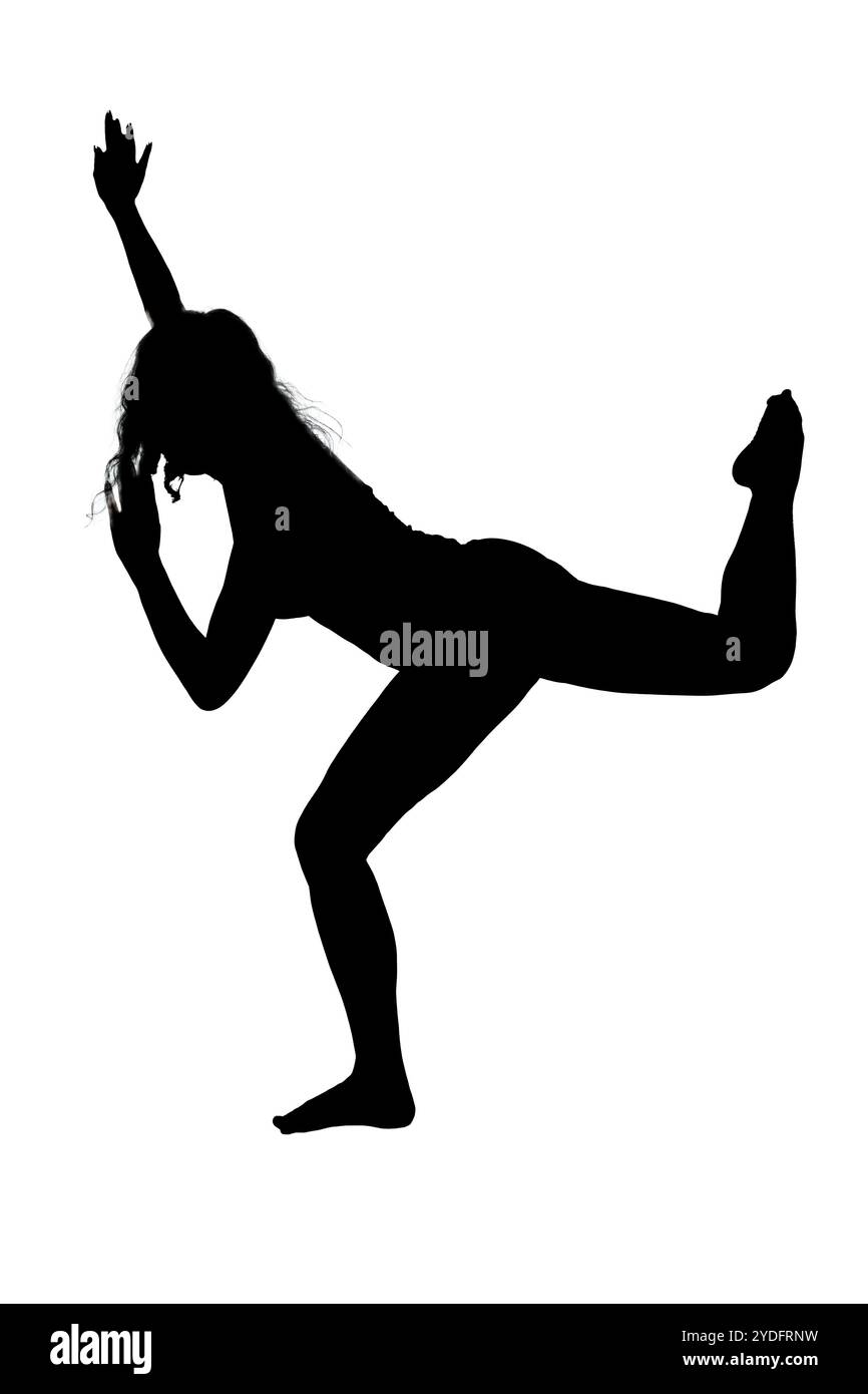 A striking silhouette of a woman gracefully executing a handstand ...