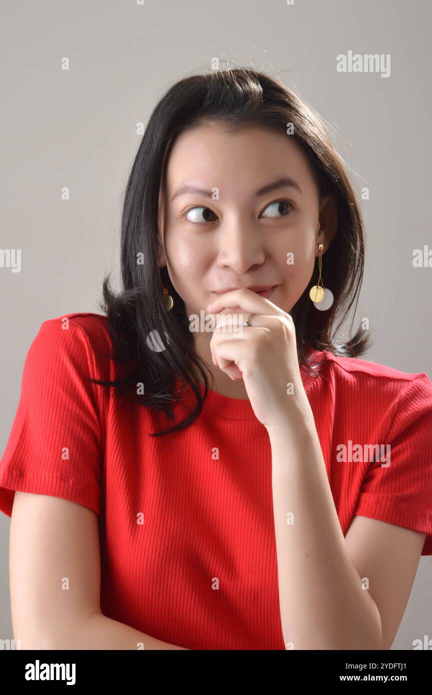 beautiful asian chinese girl, dressed in red casual with facial ...