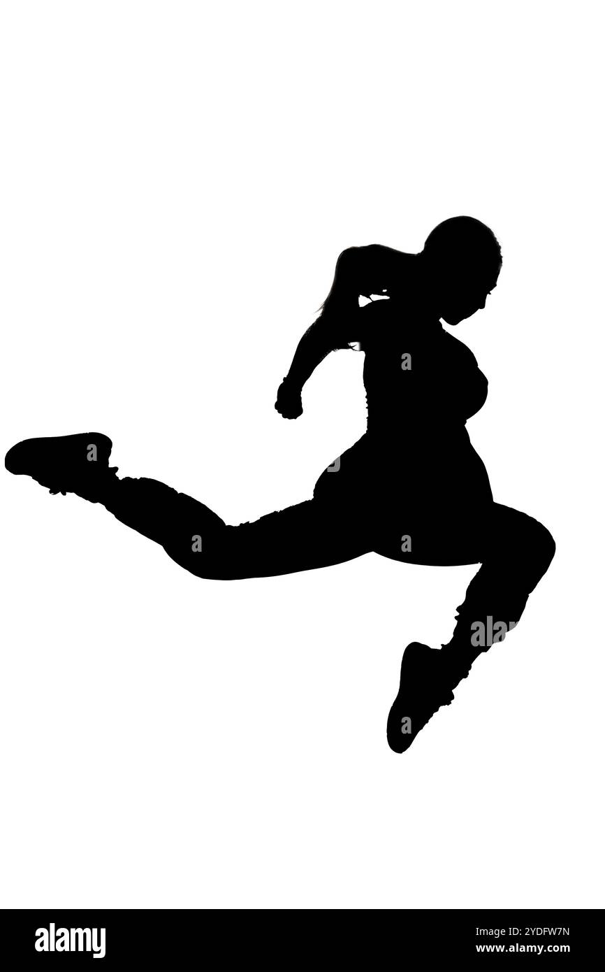 The striking silhouette of a person is seen joyfully leaping into the ...