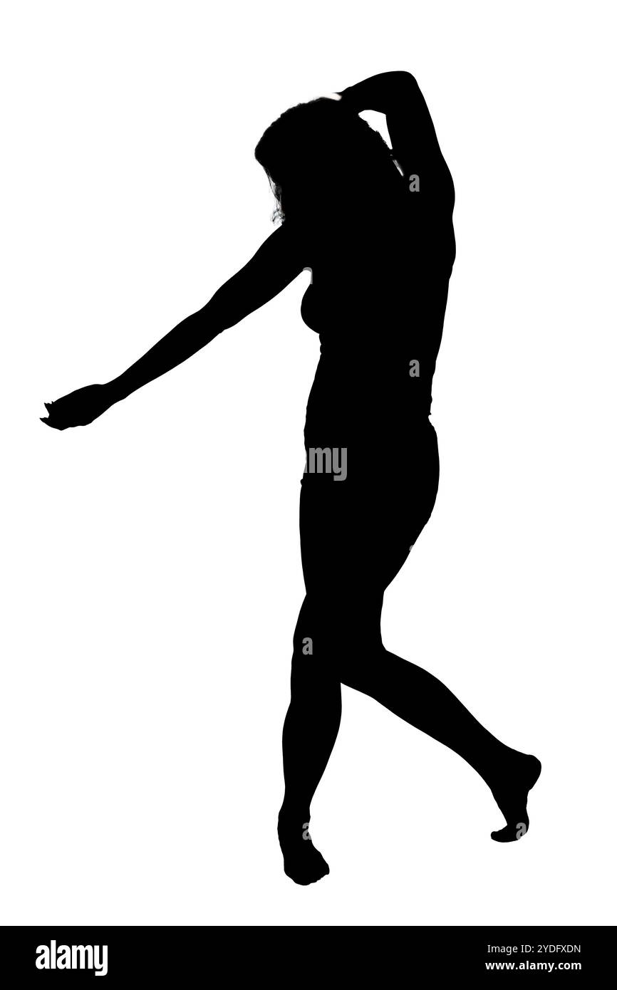 A graceful silhouette of a woman dancing elegantly against a pure white ...